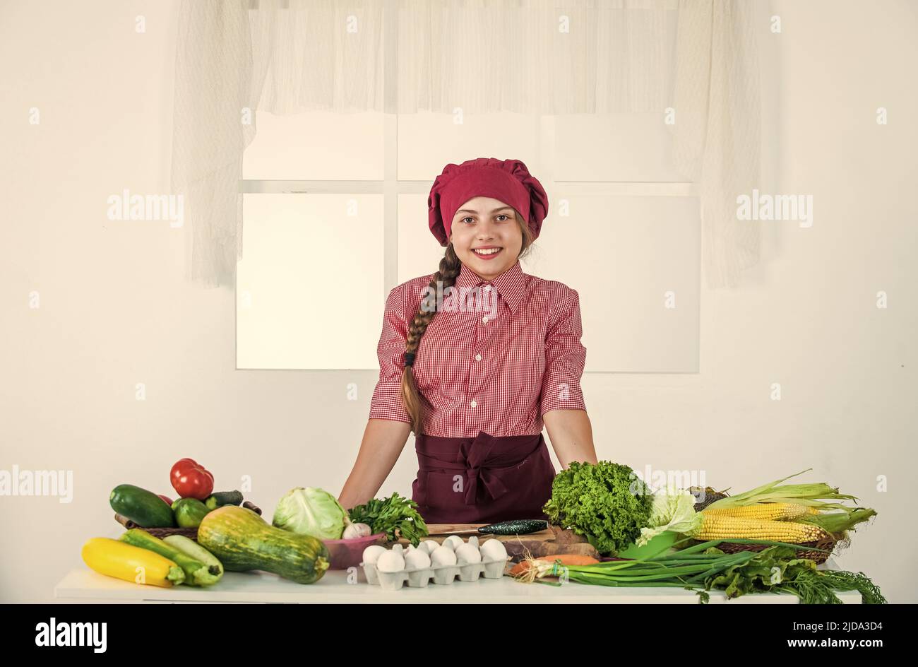 happy kid girl in cook hat and apron in kitchen, dieting Stock Photo ...