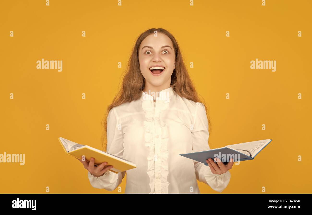 surprised teen girl ready to study do homework with book on yellow ...