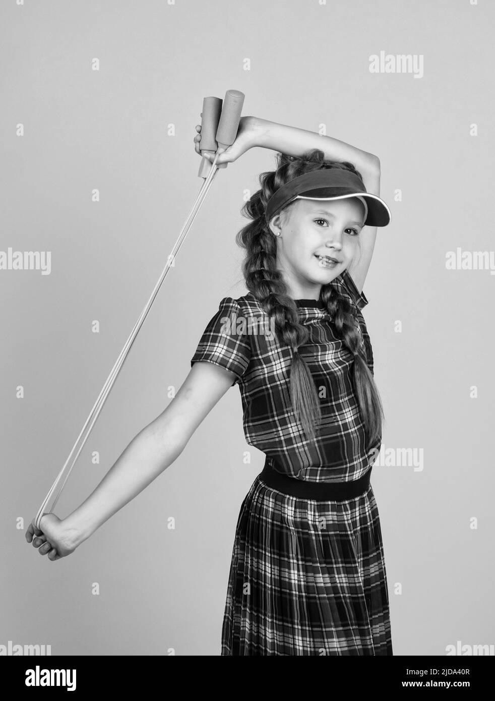 teen kid in fitness cap holding skipping rope for jumping, activity ...