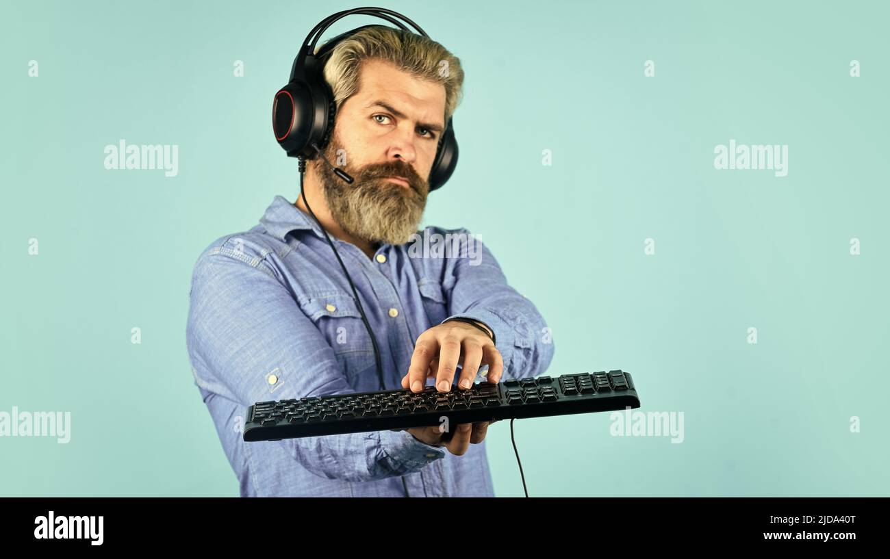 Gaming addiction. Man bearded hipster gamer headphones and keyboard ...