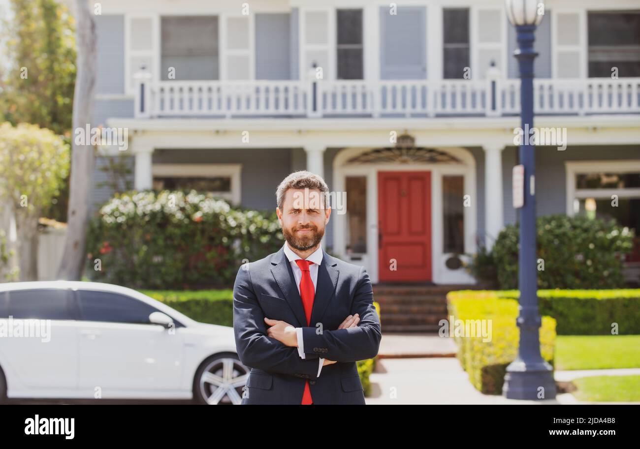 Real estate. Agent ready to sell home. Businessman standing outside a ...