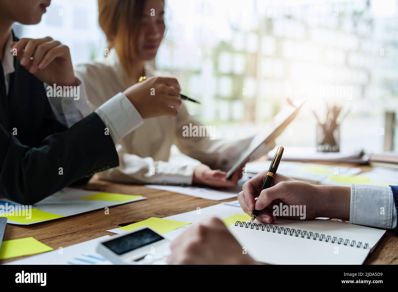 Male businessman holding pen to take notes summarizing marketing ...