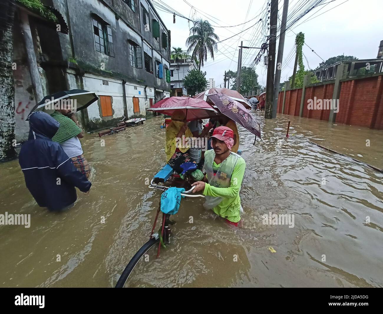 Sylhet, Bangladesh. 19th June 2022. People traveling in rickshaws to hospital during floods. The ...