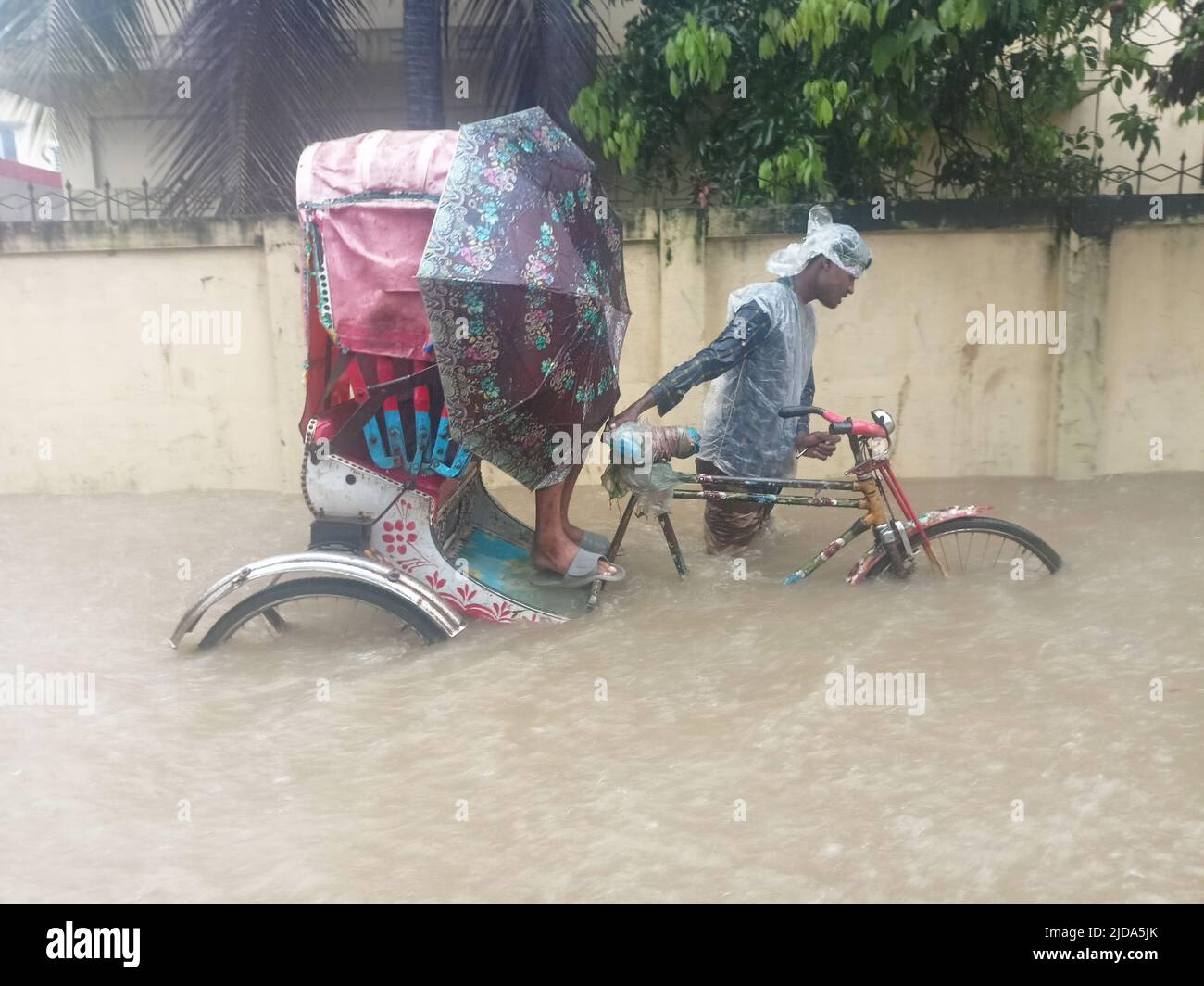 Sylhet, Bangladesh. 19th June 2022. People traveling in rickshaws to hospital during floods. The ...