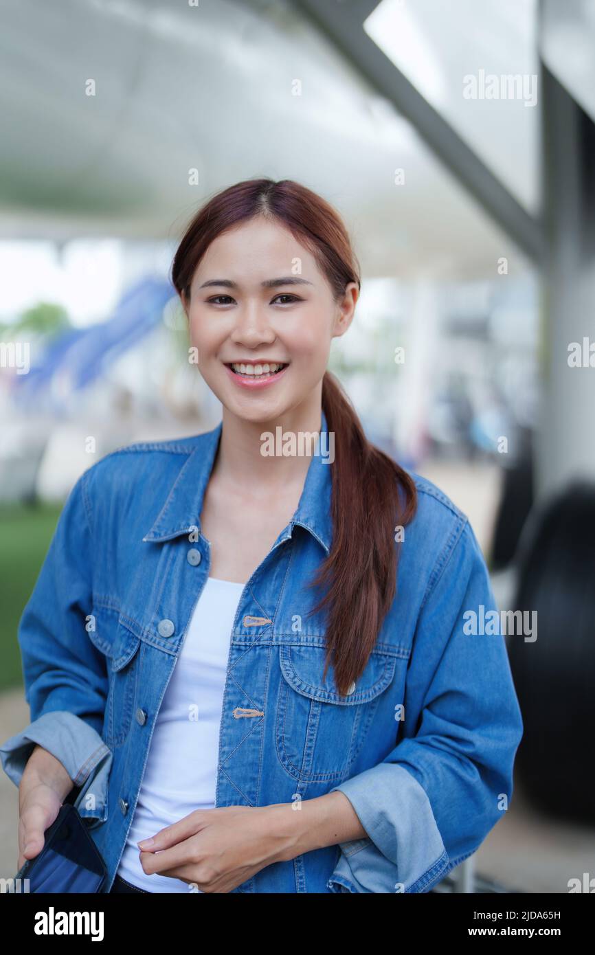 travel business Portrait of an Asian woman showing joy while waiting ...