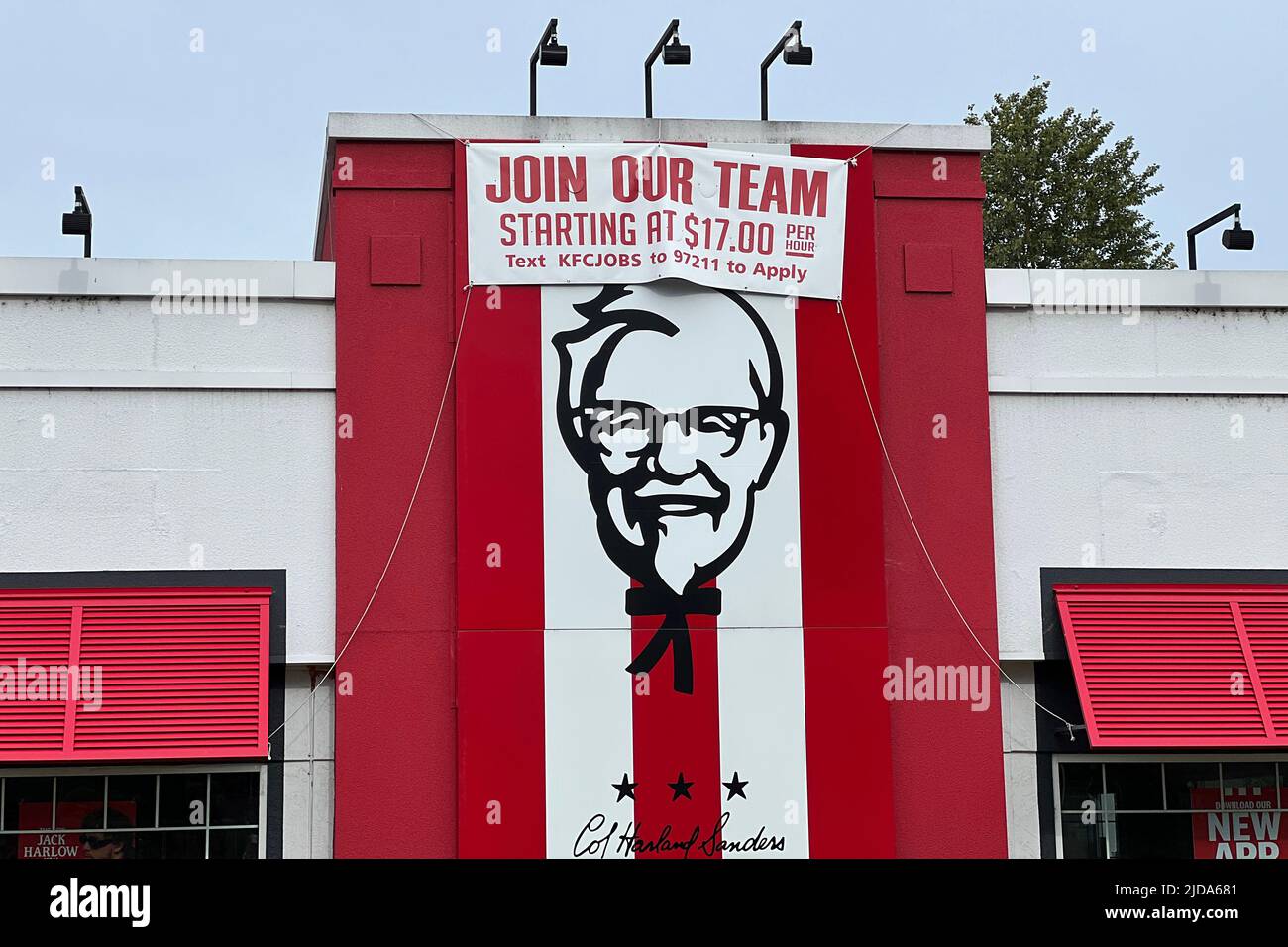 A now hiring employees sign at a Kentucky Fried Chicken (KFC) fast food ...