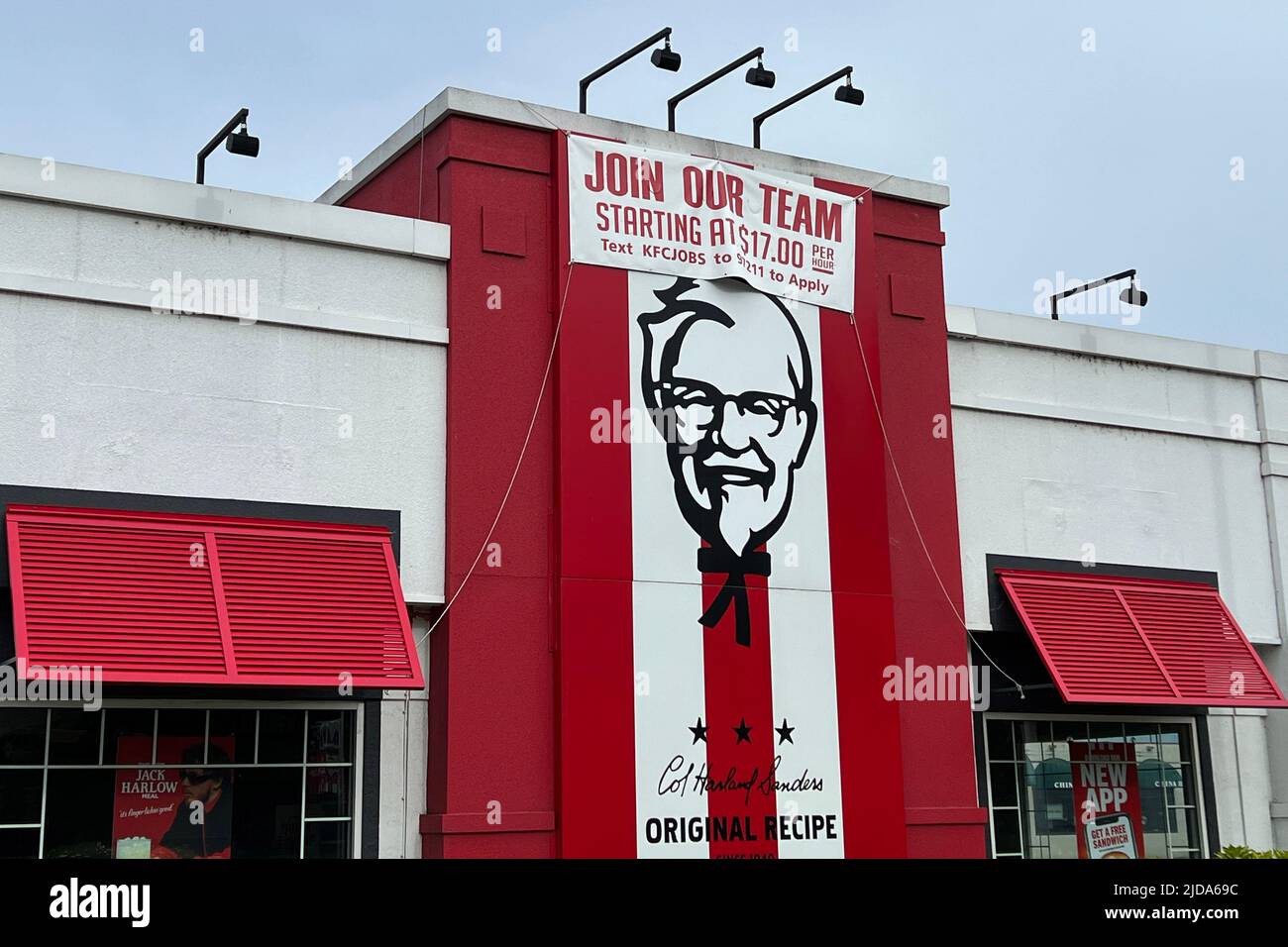 A now hiring employees sign at a Kentucky Fried Chicken (KFC) fast food ...