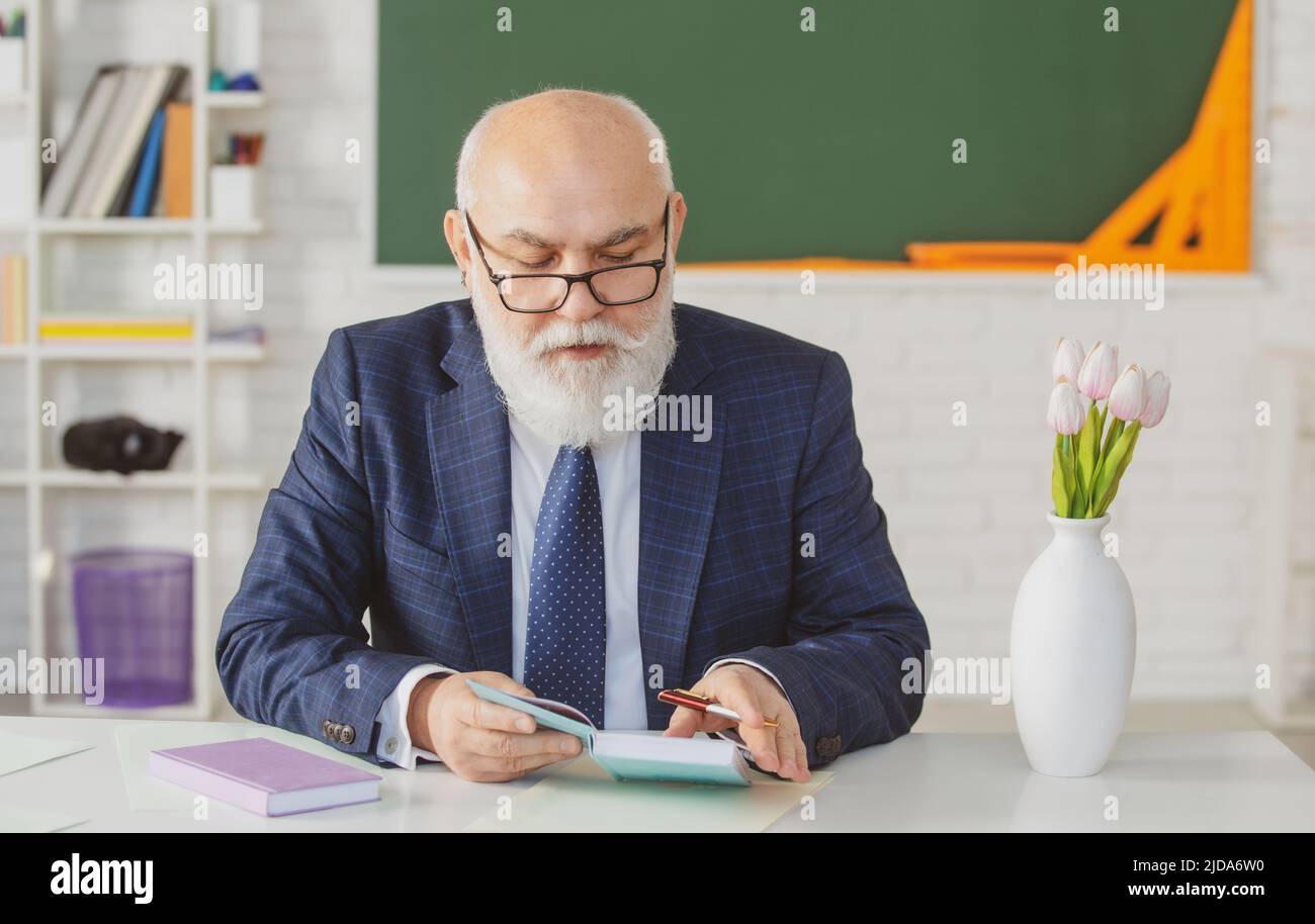 Old Male Teacher Sitting In The Classroom Elderly Senior Professor