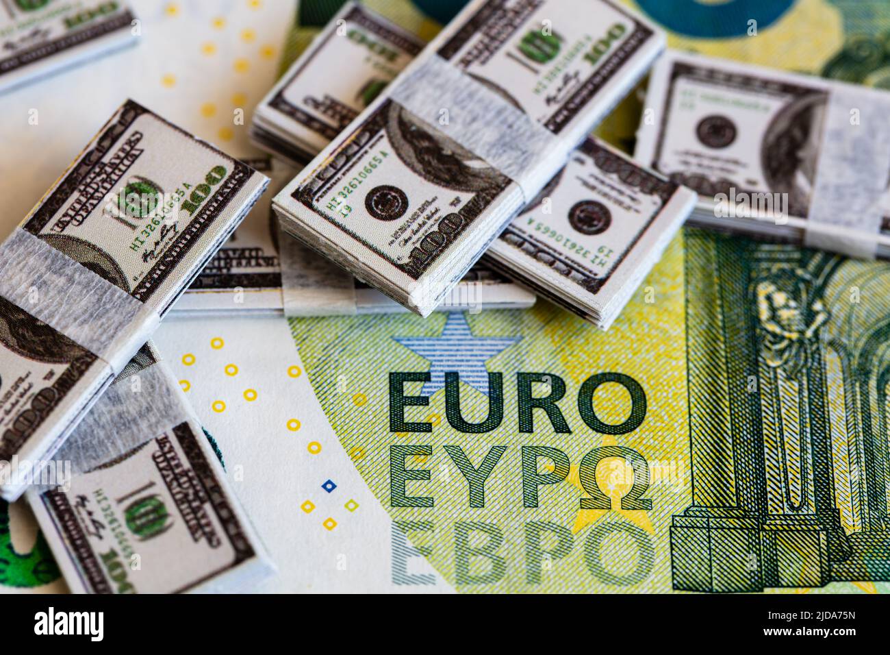 bundles of miniature 100 dollar banknotes on 100 euro banknote ...