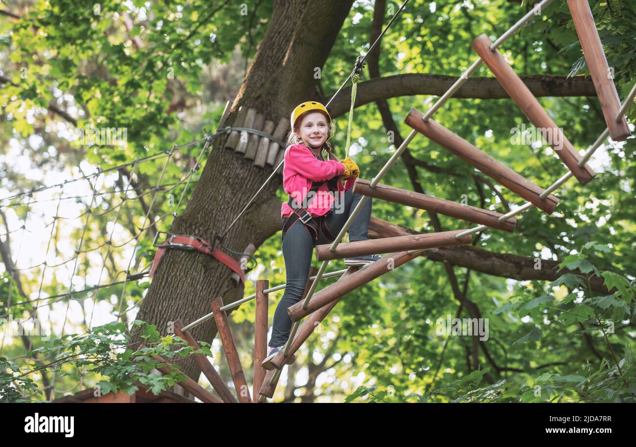 Climber child on training. Happy child boy calling while climbing high ...