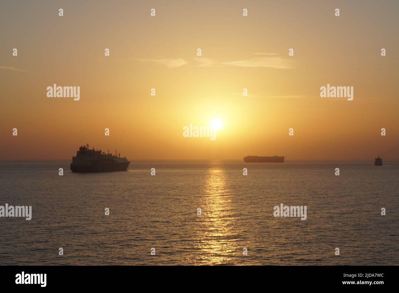 Cargo merchant vessels at anchor during sunset in Mediterranean Sea ...