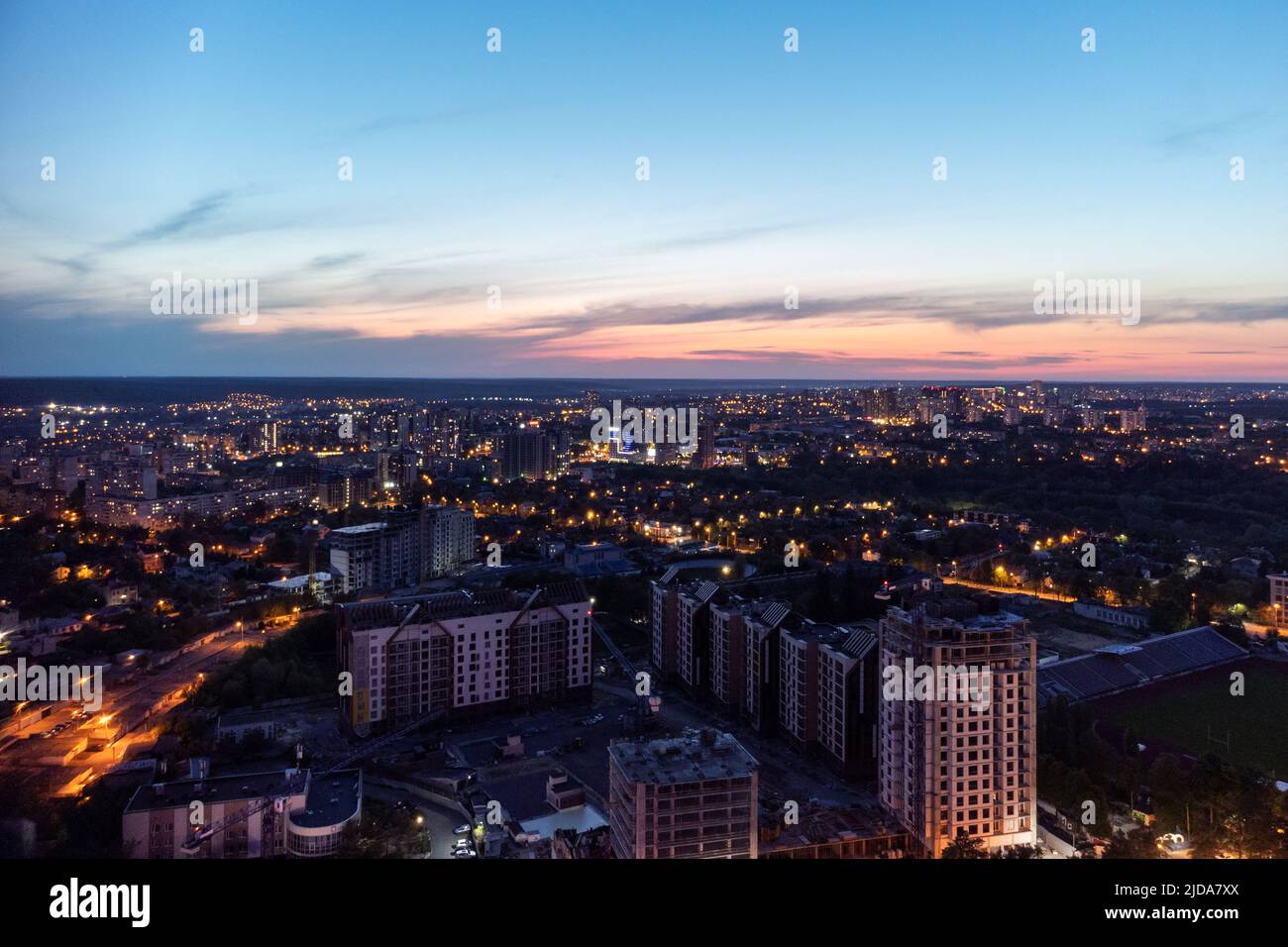 Aerial view on vivid evening cityscape, city residential buildings ...