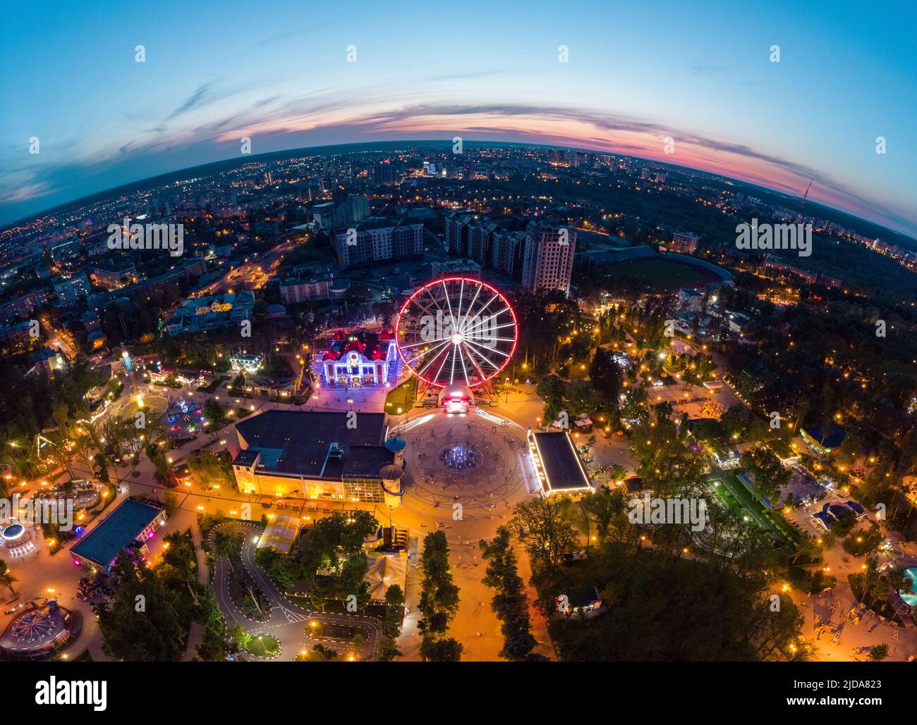 Aerial view on vivid evening cityscape, Ferris wheel and entertainments ...