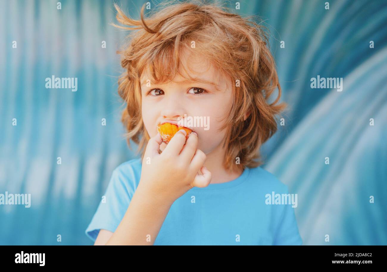 Little boy child eating cookies outdoors in sunny summer day. Kids ...