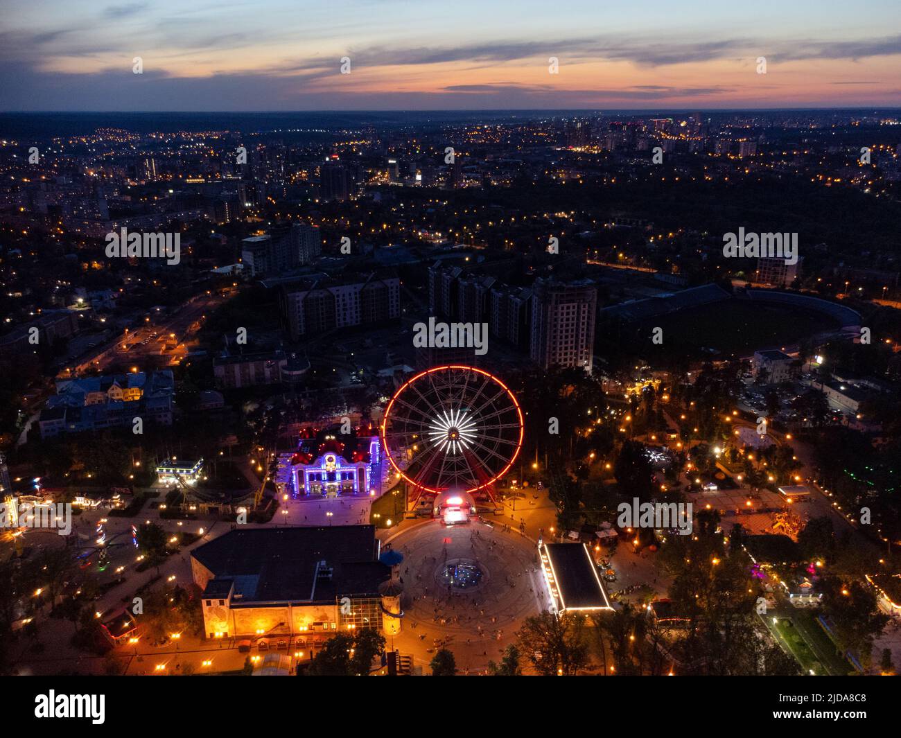 Aerial illuminated Ferris wheel. Kharkiv city center recreation area in ...