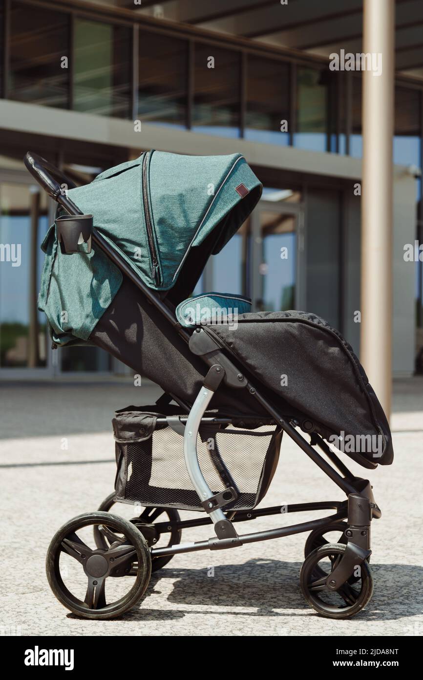 Modern contemporary green baby stroller outdoors side view Stock Photo ...