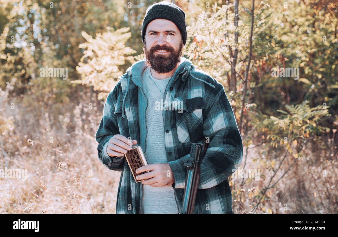 Hunter with shotgun gun on hunt. Close up Portrait of hamdsome Hunter ...