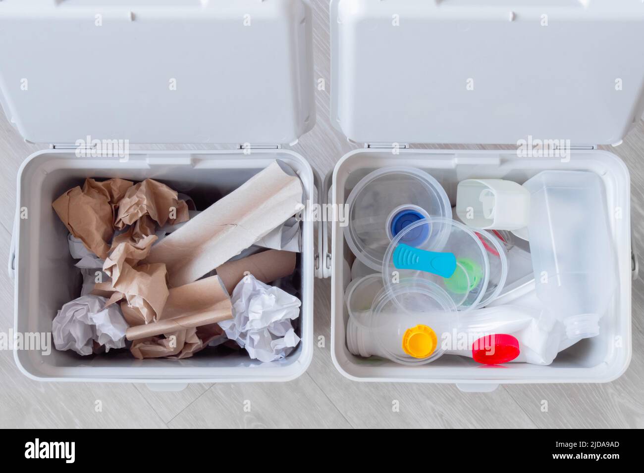 Top view: sorting of garbage in two recycling bins, garbage baskets at ...