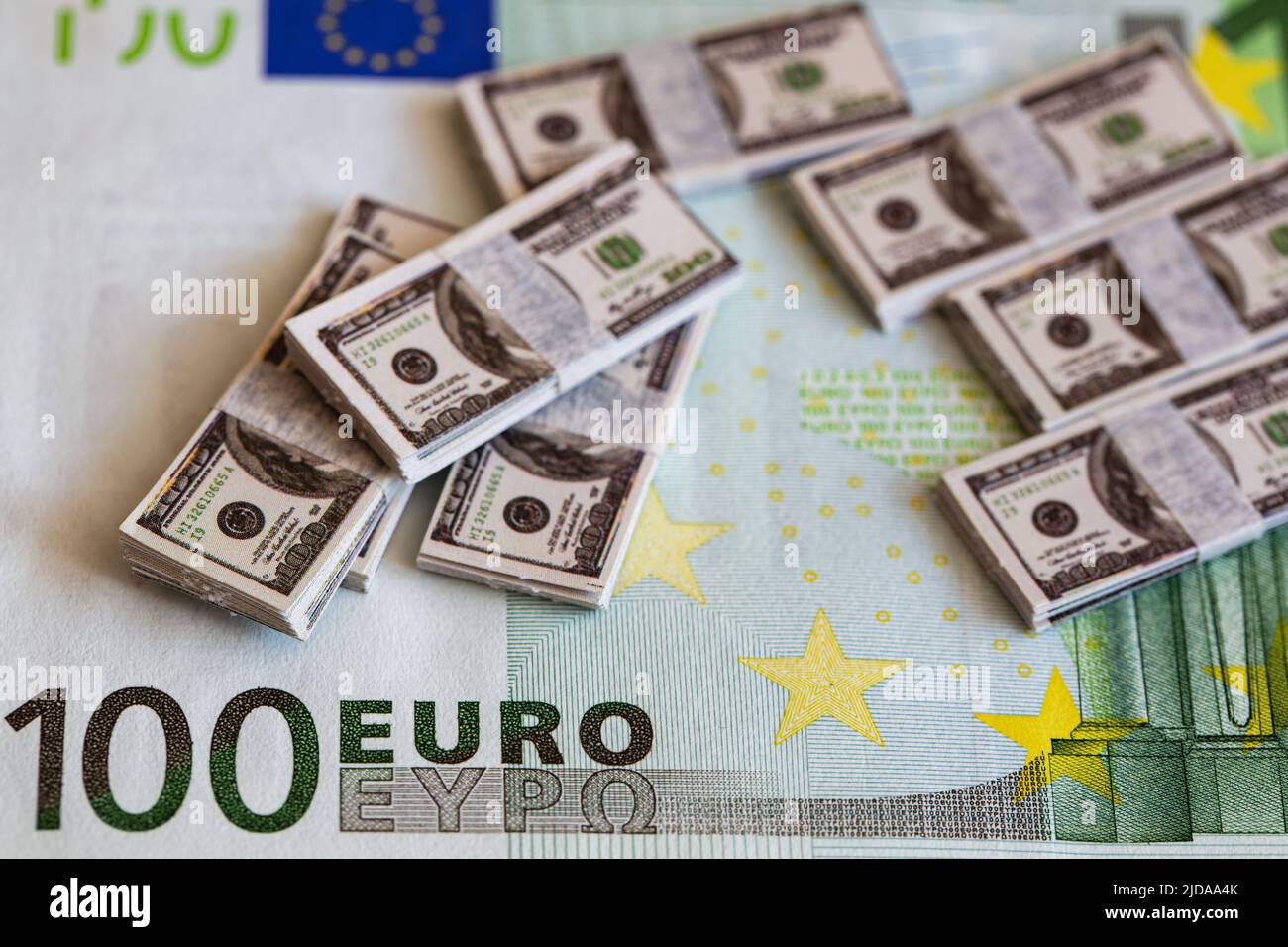 bundles of miniature 100 dollar banknotes on 100 euro banknote ...