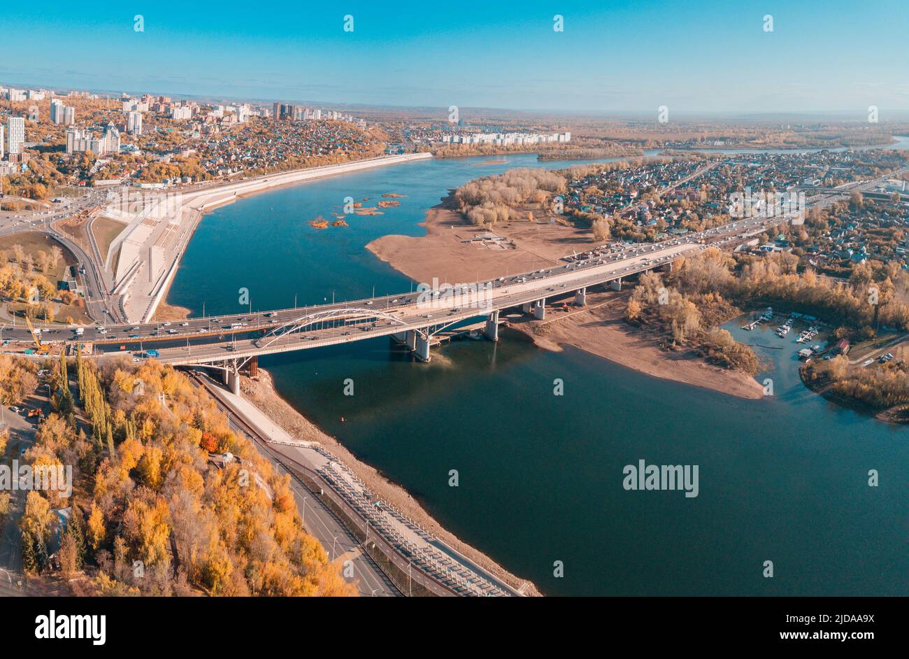 Aerial cityscape view of city districts with automobile bridge over ...
