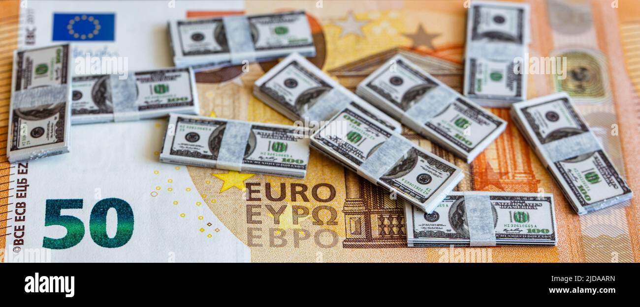 bundles of miniature 100 dollar banknotes on 50 euro banknote ...