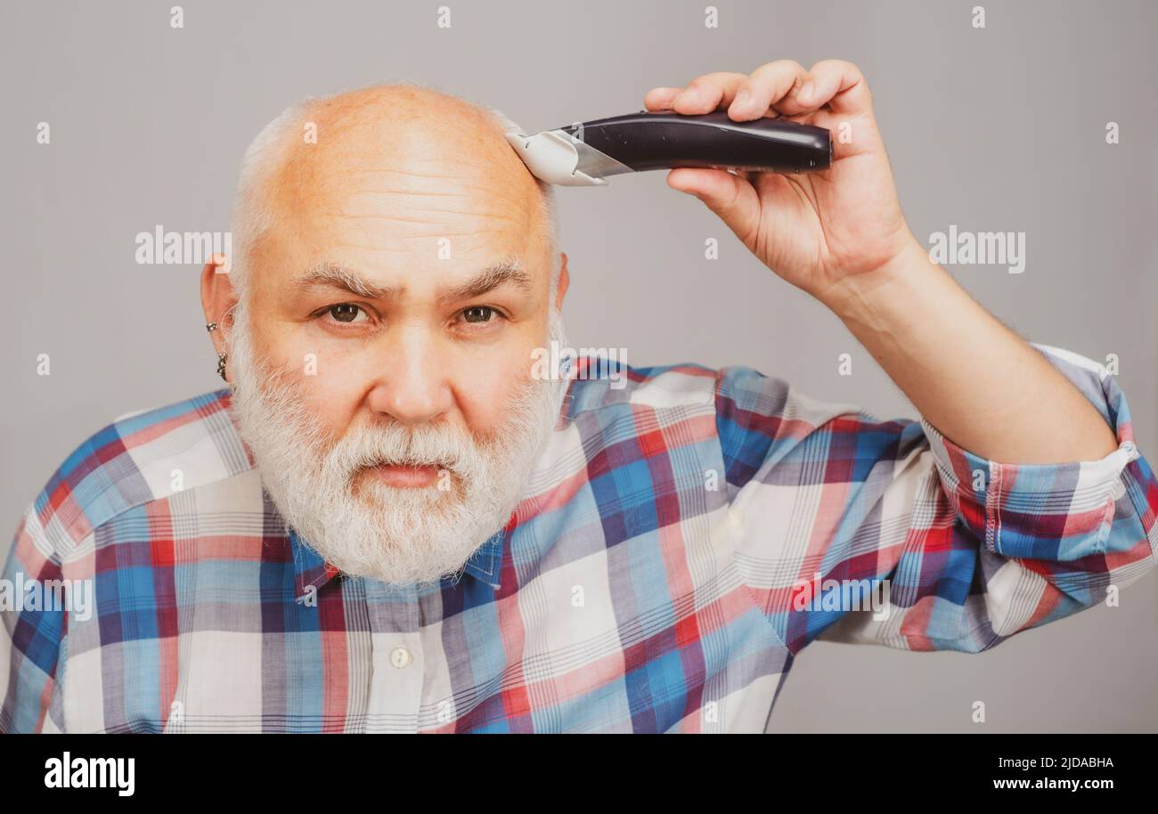 Bald man hairclipper, Mature baldness and hair loss concept. Middle ...