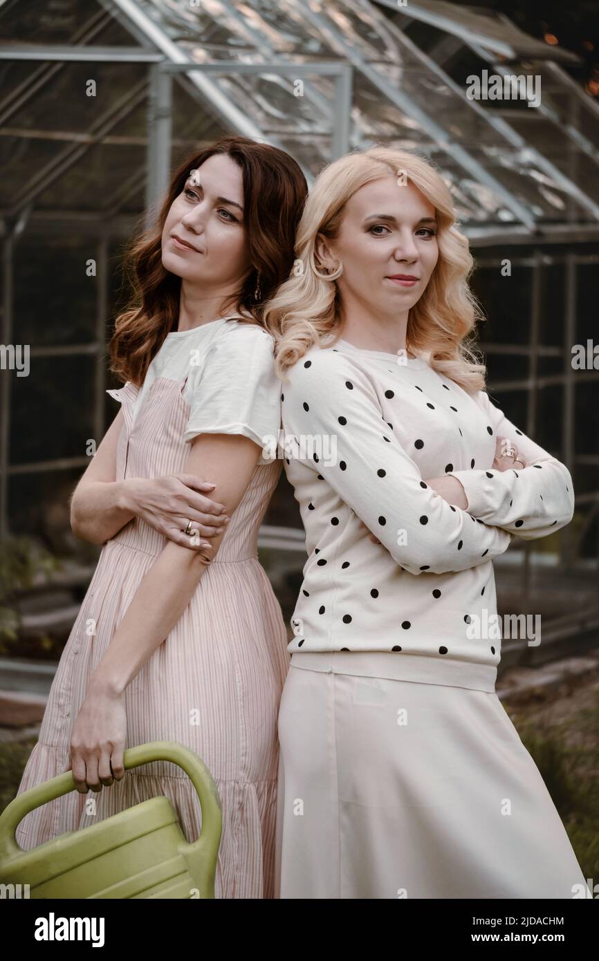 Two mature sisters in the garden in the evening. Portrait of Woman at ...