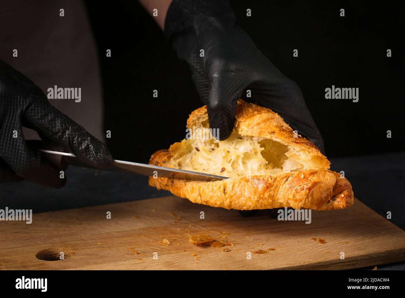 The chef prepares the croissant with the filling Stock Photo - Alamy
