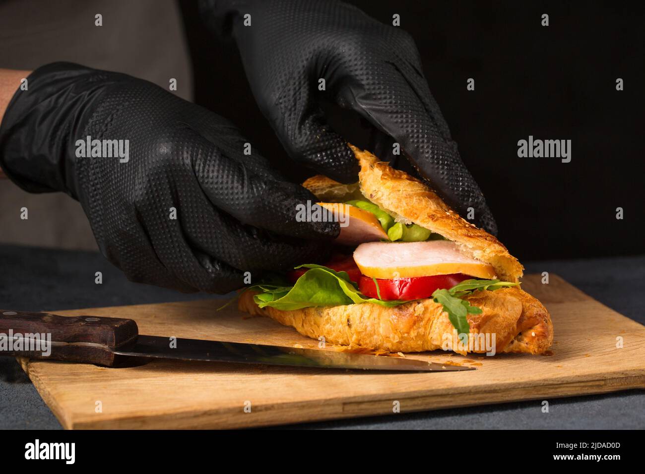 The chef prepares the croissant with the filling Stock Photo - Alamy
