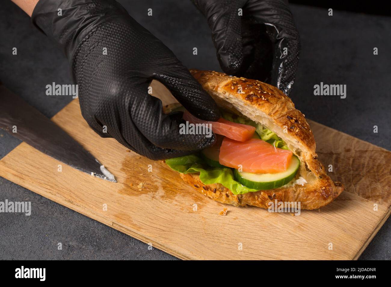 The chef prepares the croissant with the filling Stock Photo - Alamy