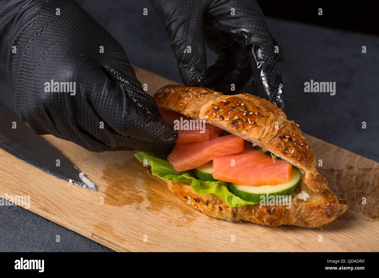 The chef prepares the croissant with the filling Stock Photo - Alamy