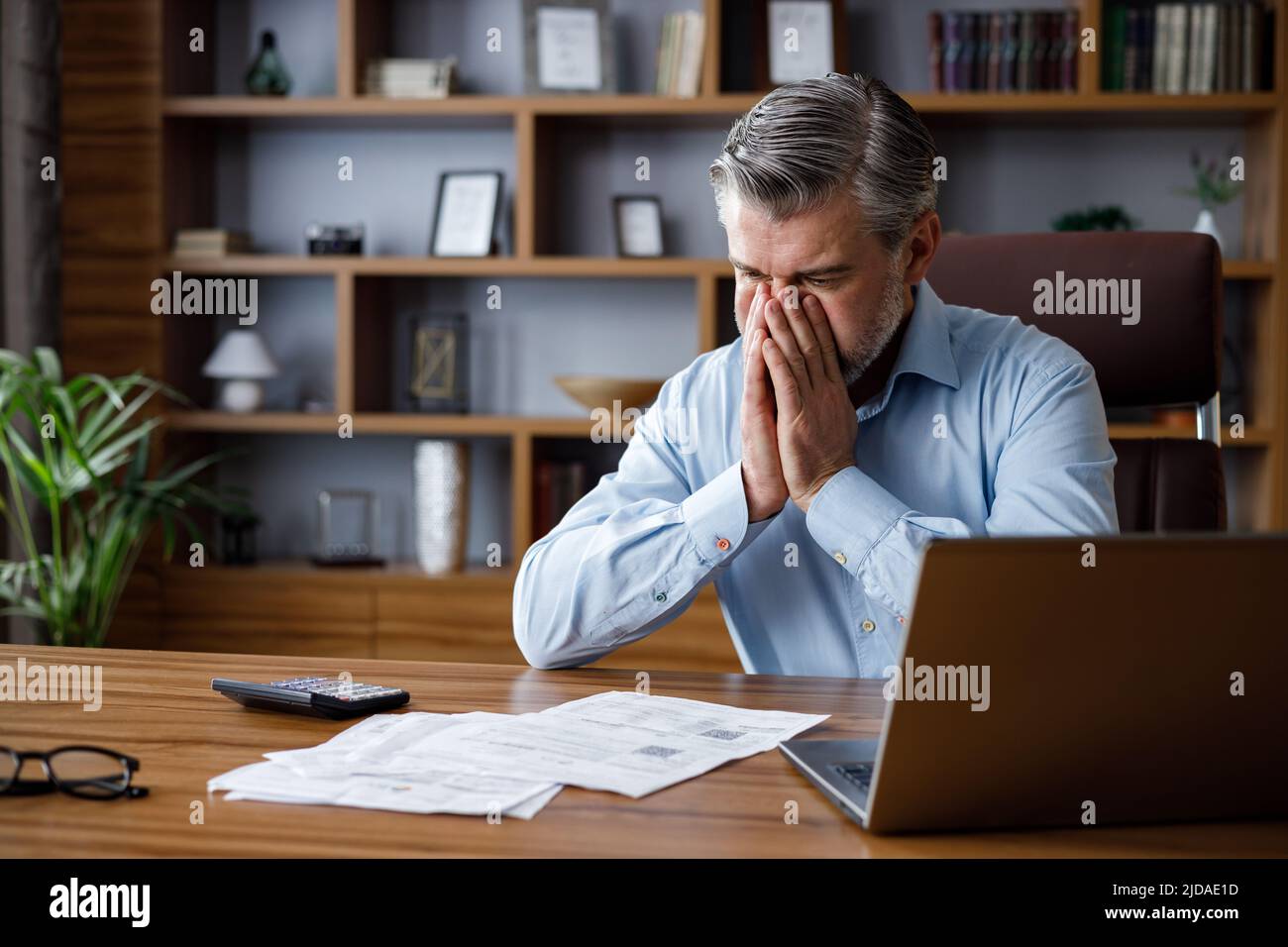 Serious businessman paying bills hi-res stock photography and images ...