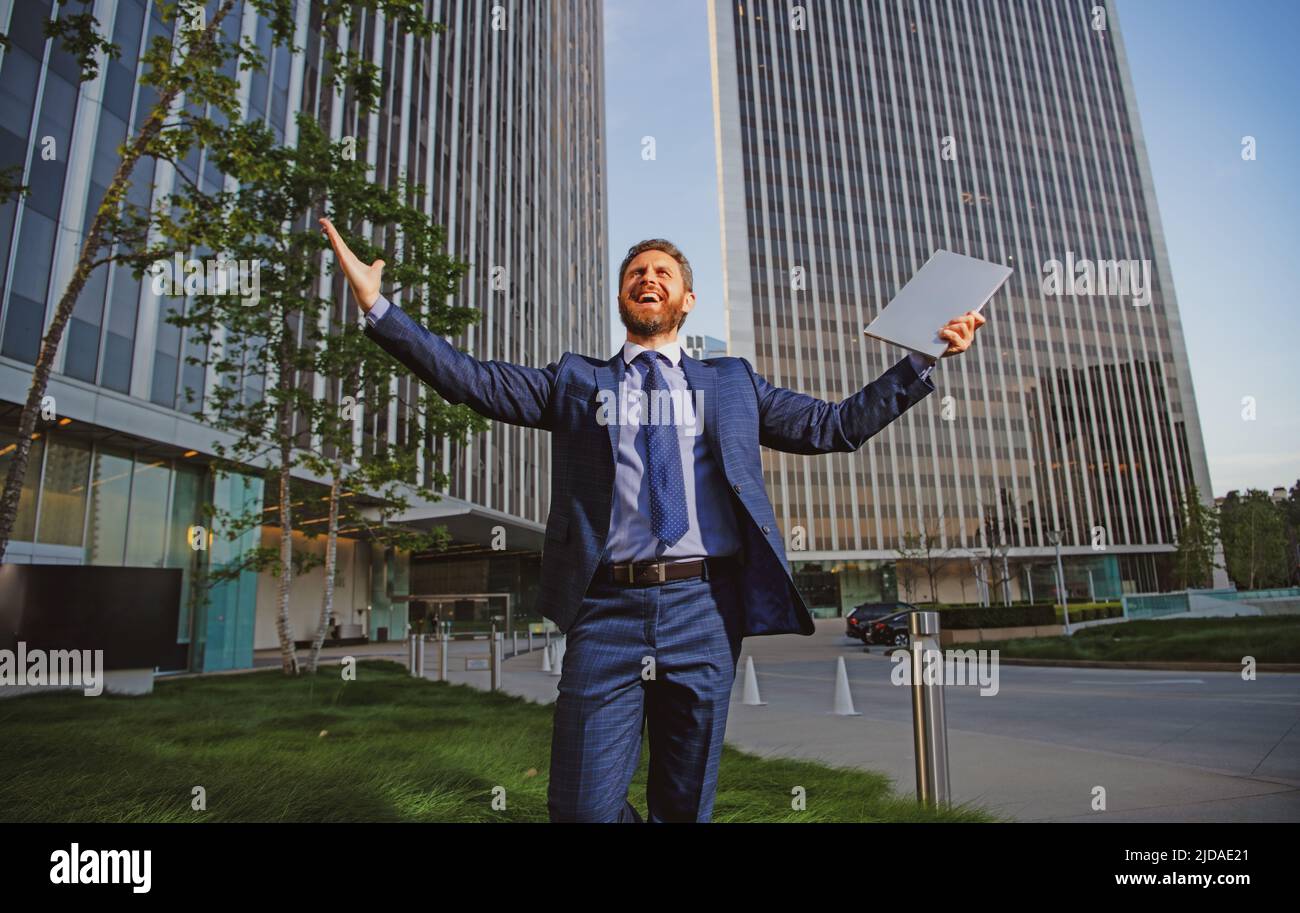 Welcome business. Happy leader standing in front of company building ...