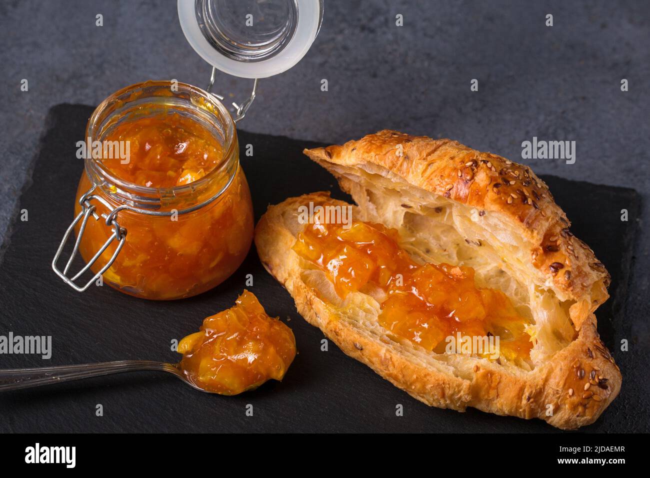 Ruddy, crunchy croissant with homemade orange jam Stock Photo - Alamy
