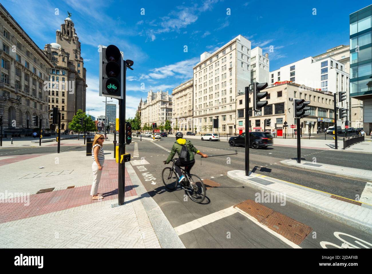 Cyclist passing through a traffic light controlled bike lane in ...