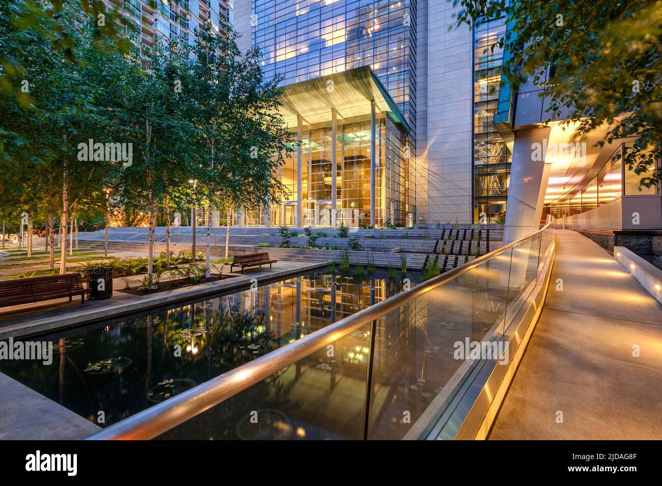 Seattle, a city plaza with modern architecture and water pool at night ...