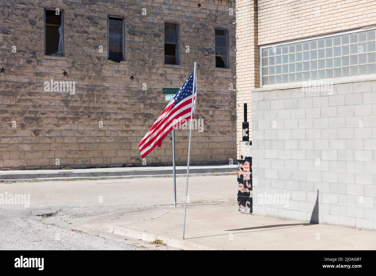 American flag flying outside a building on a main street Stock Photo ...