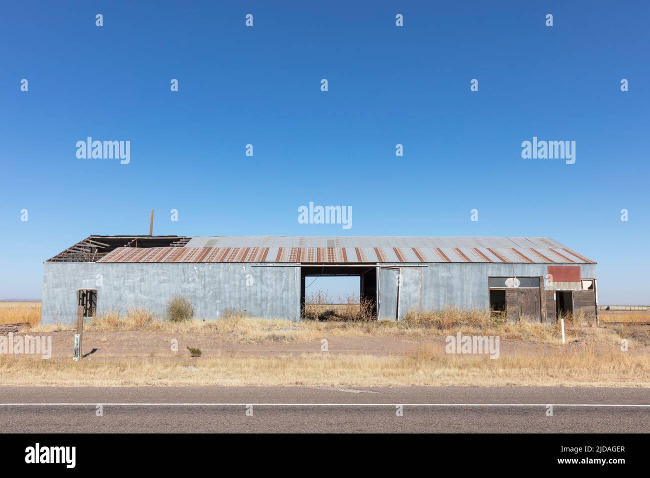Abandoned rusting metal farm building with large open doors Stock Photo ...