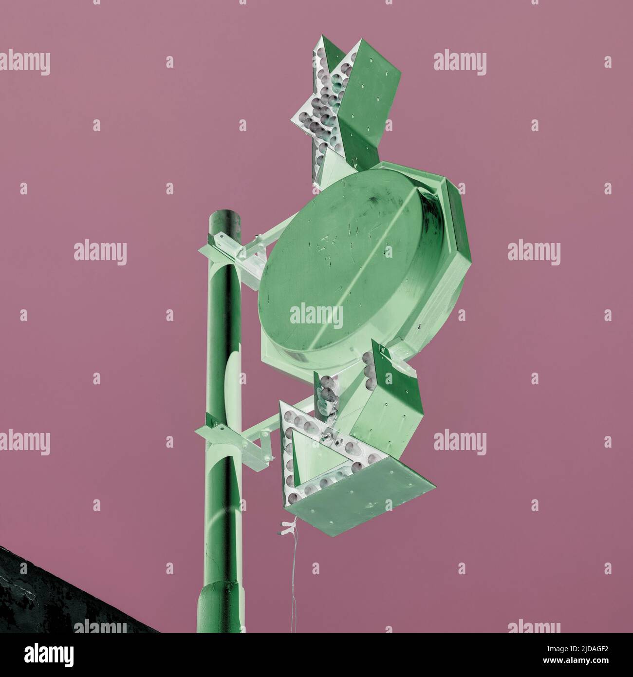 An advertising sign with arrows and lights on a post, inverted image ...