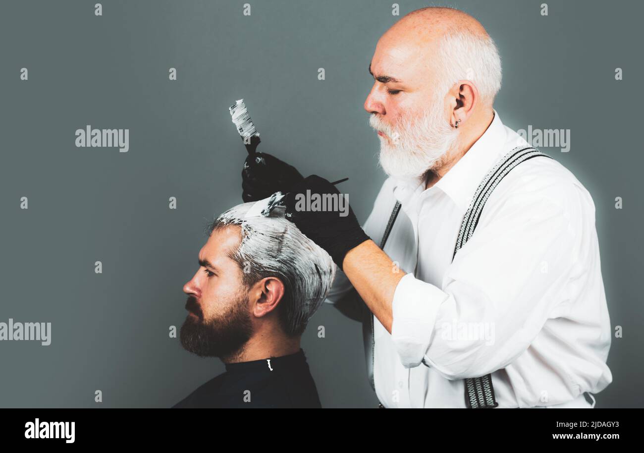 Hair coloring man. Barber make a coloring haircut Stock Photo - Alamy