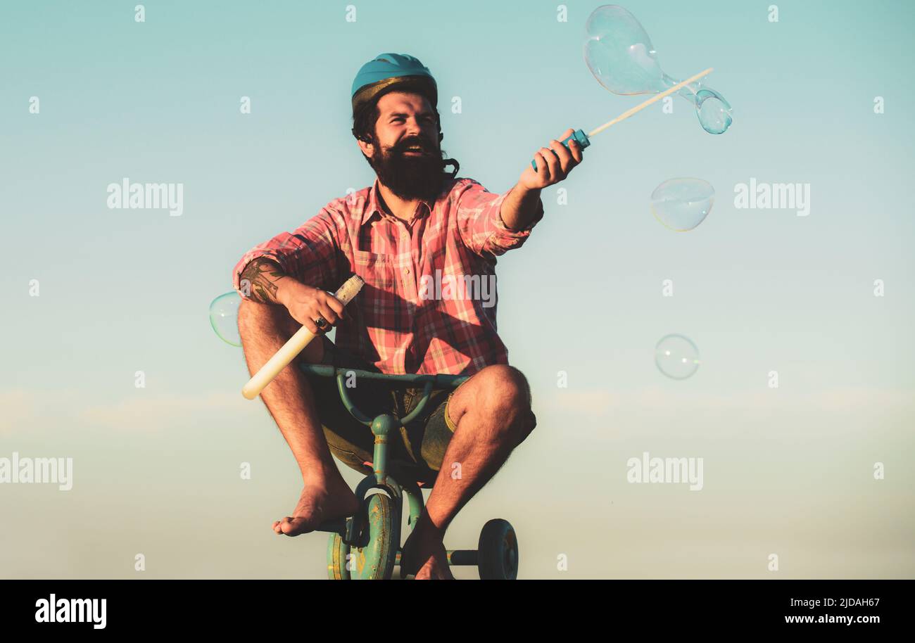 Childhood memory. Funny crazy man riding a bike Stock Photo - Alamy