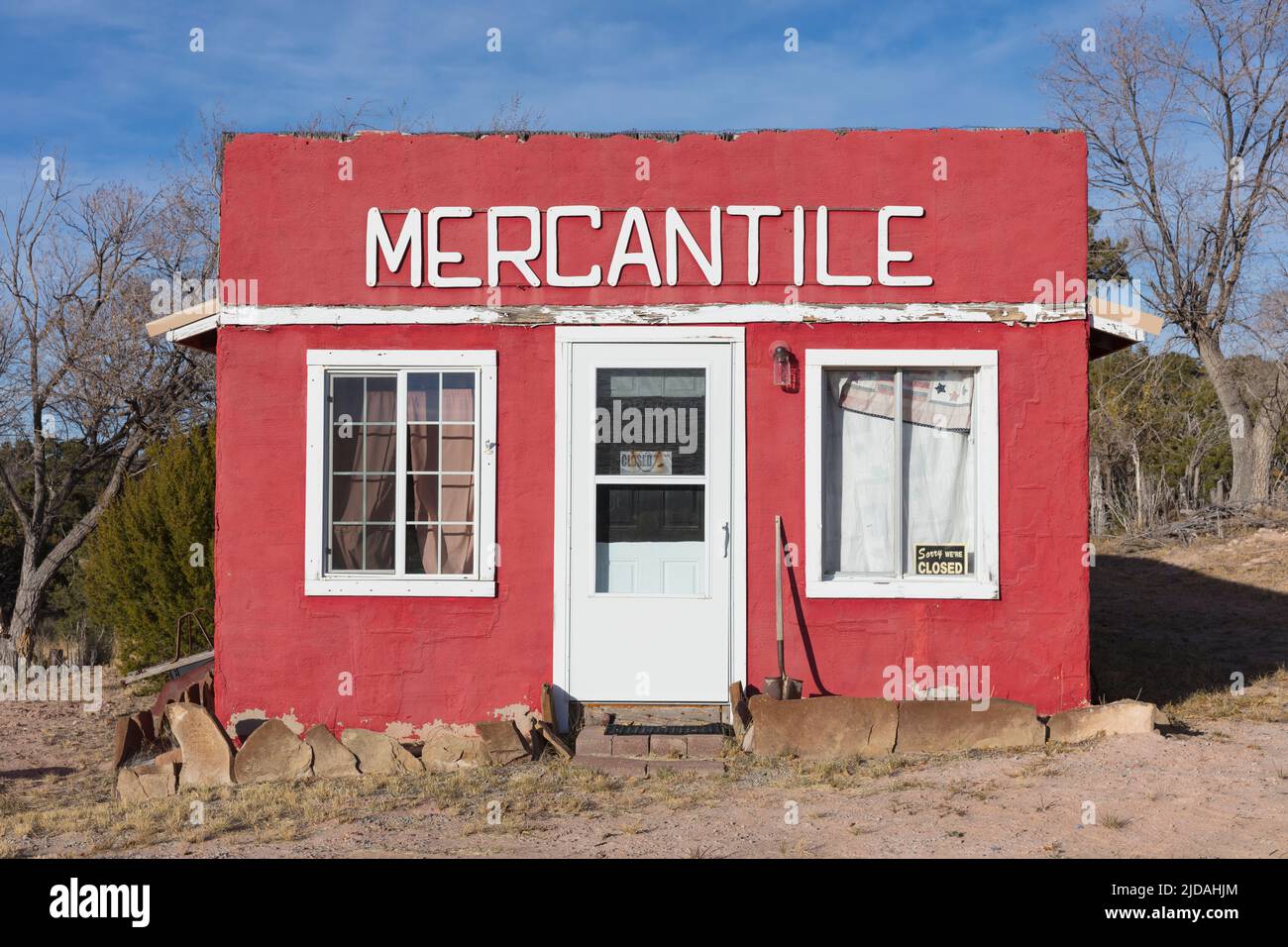 A red painted building frontage, with a sign MERCANTILE, windows ...