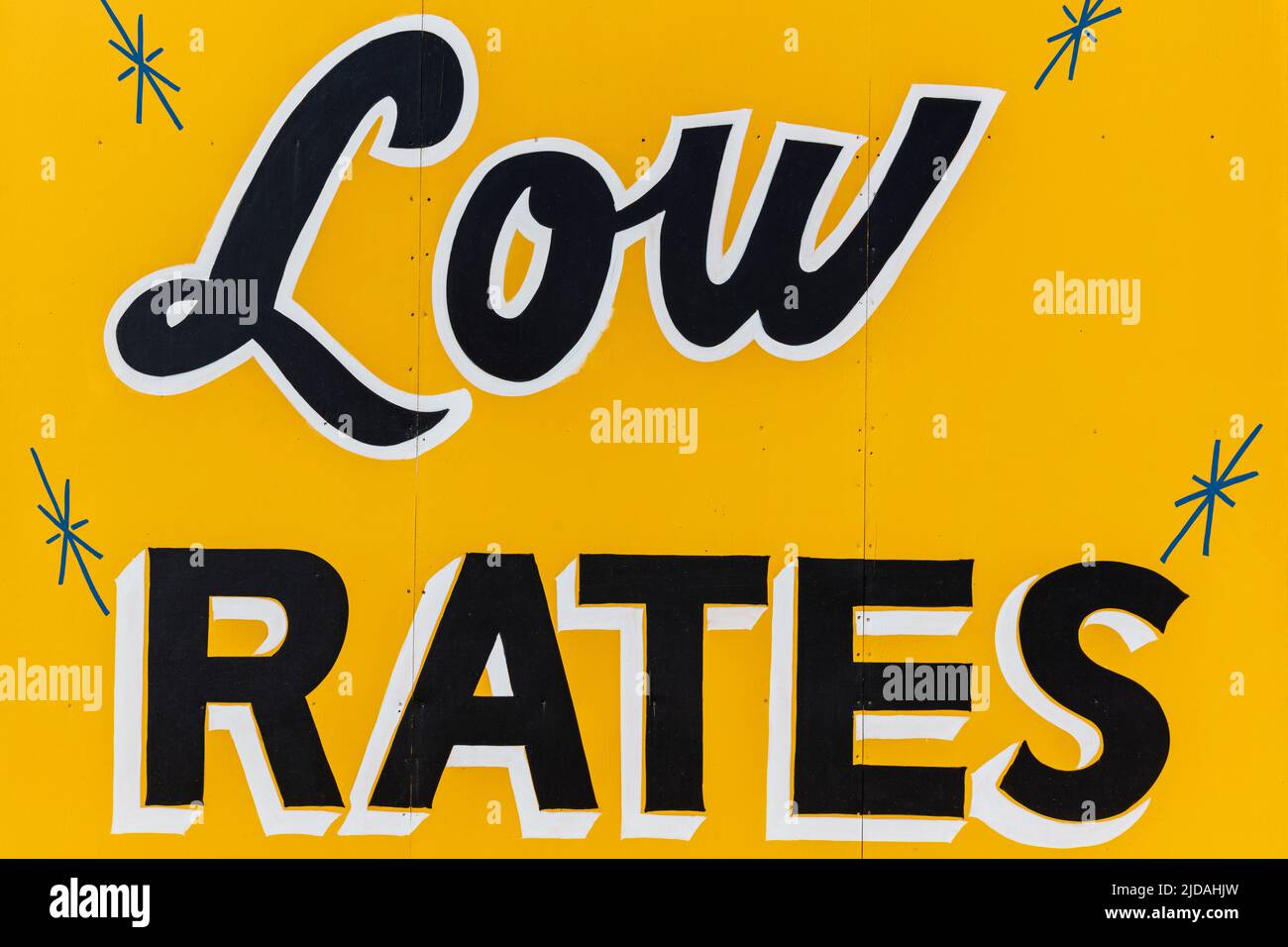 LOW RATES billboard, yellow sign, advertising, close up Stock Photo - Alamy