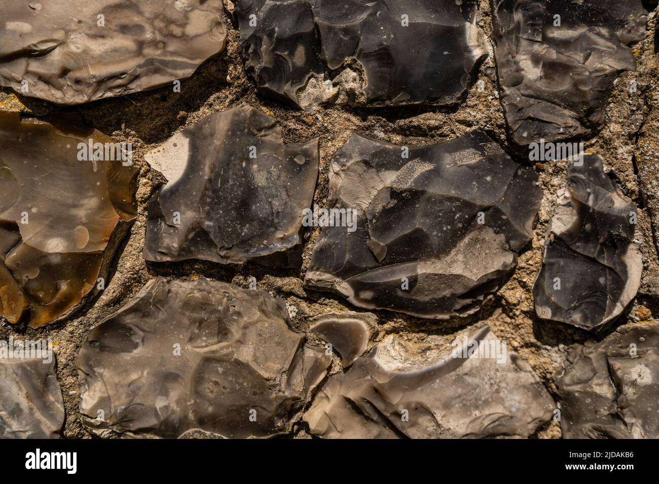 Closeup on various flint stones used in UK as a building material in architecture. Flint is the ...