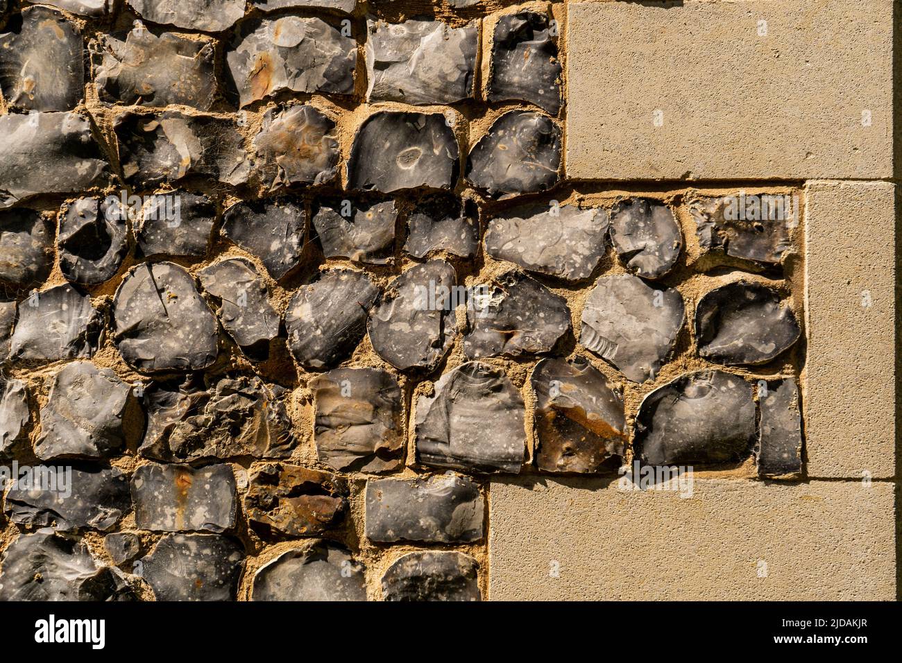 Closeup on various flint stones used in UK as a building material in architecture. Flint is the ...