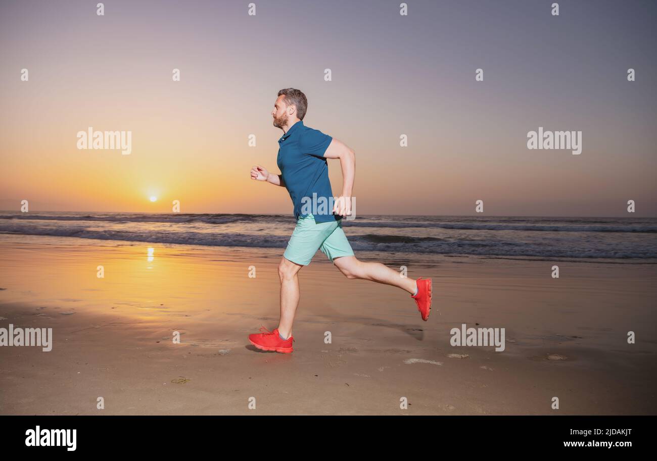 Athletic young man running. Fit male fitness runner during outdoor ...