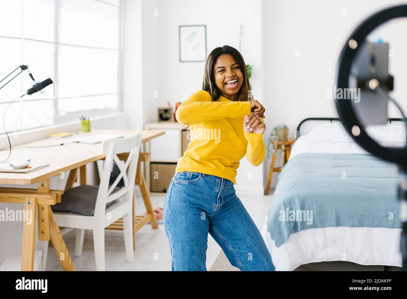 Hispanic latina young creator woman dancing while streaming online with ...