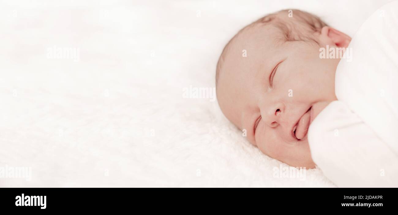 Newborn baby in crib on white blanket, baby portrait 7 days old. The ...