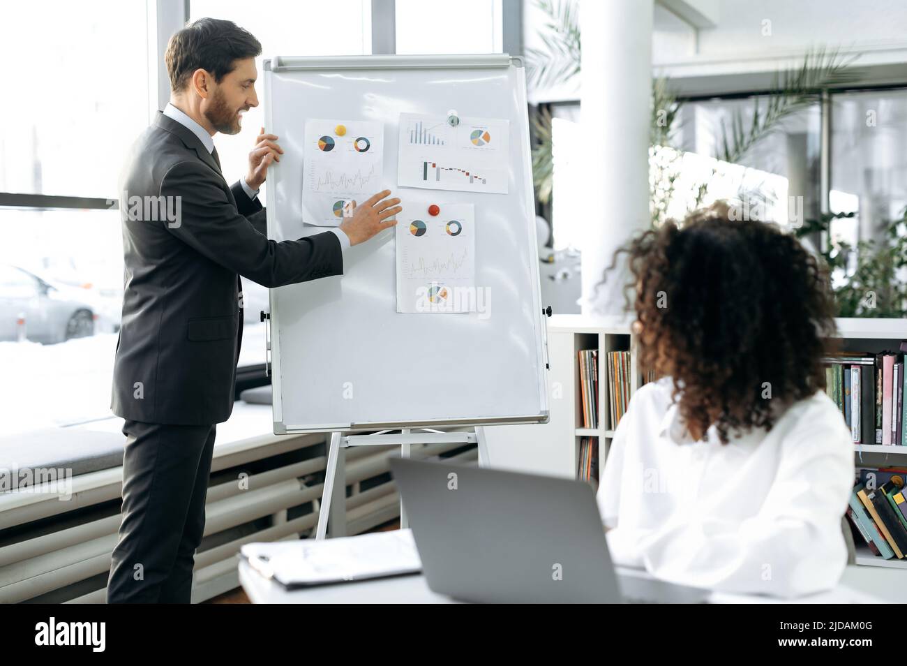 Confident intelligent caucasian businessman, ceo, stands in a modern ...