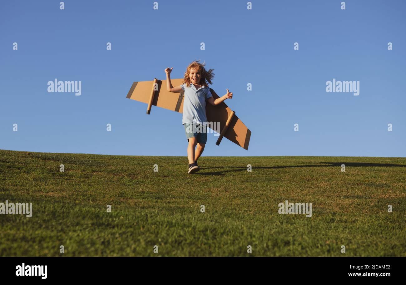 Child boy jumping and running with toy airplane wings. Dream of ...